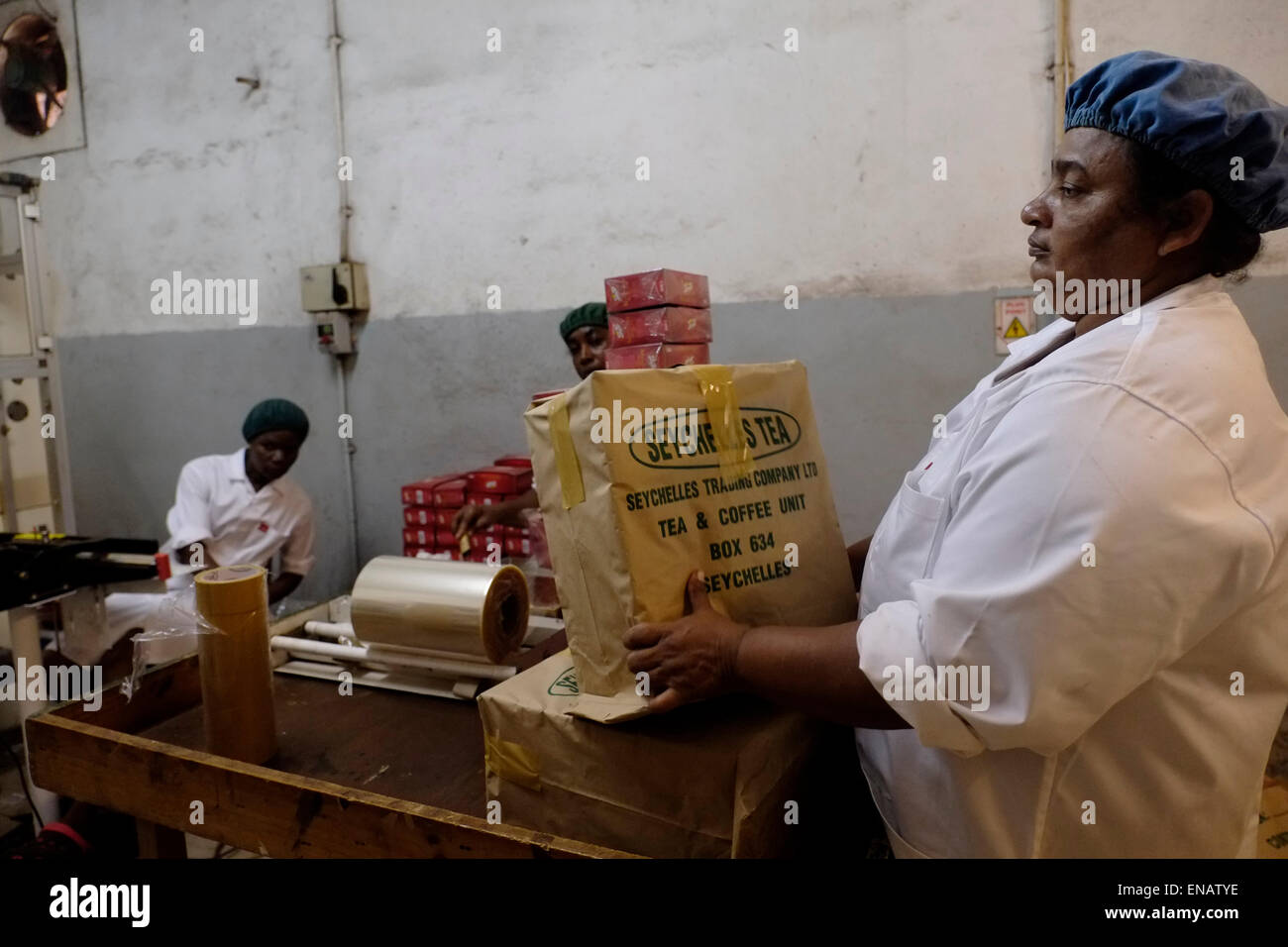 Women working at the assembly line of SeyTe tea factory in Mahe Island ...