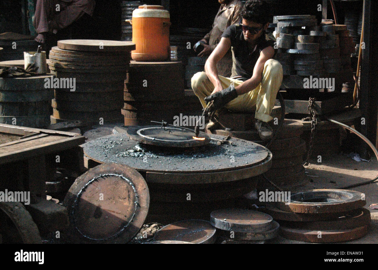 Lahore. 1st May, 2015. A Pakistani worker works at an iron factory on ...
