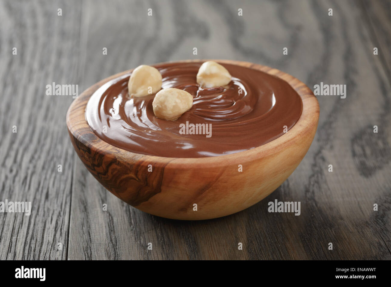 chocolate hazelnut creamin wood bowl, on old table Stock Photo - Alamy