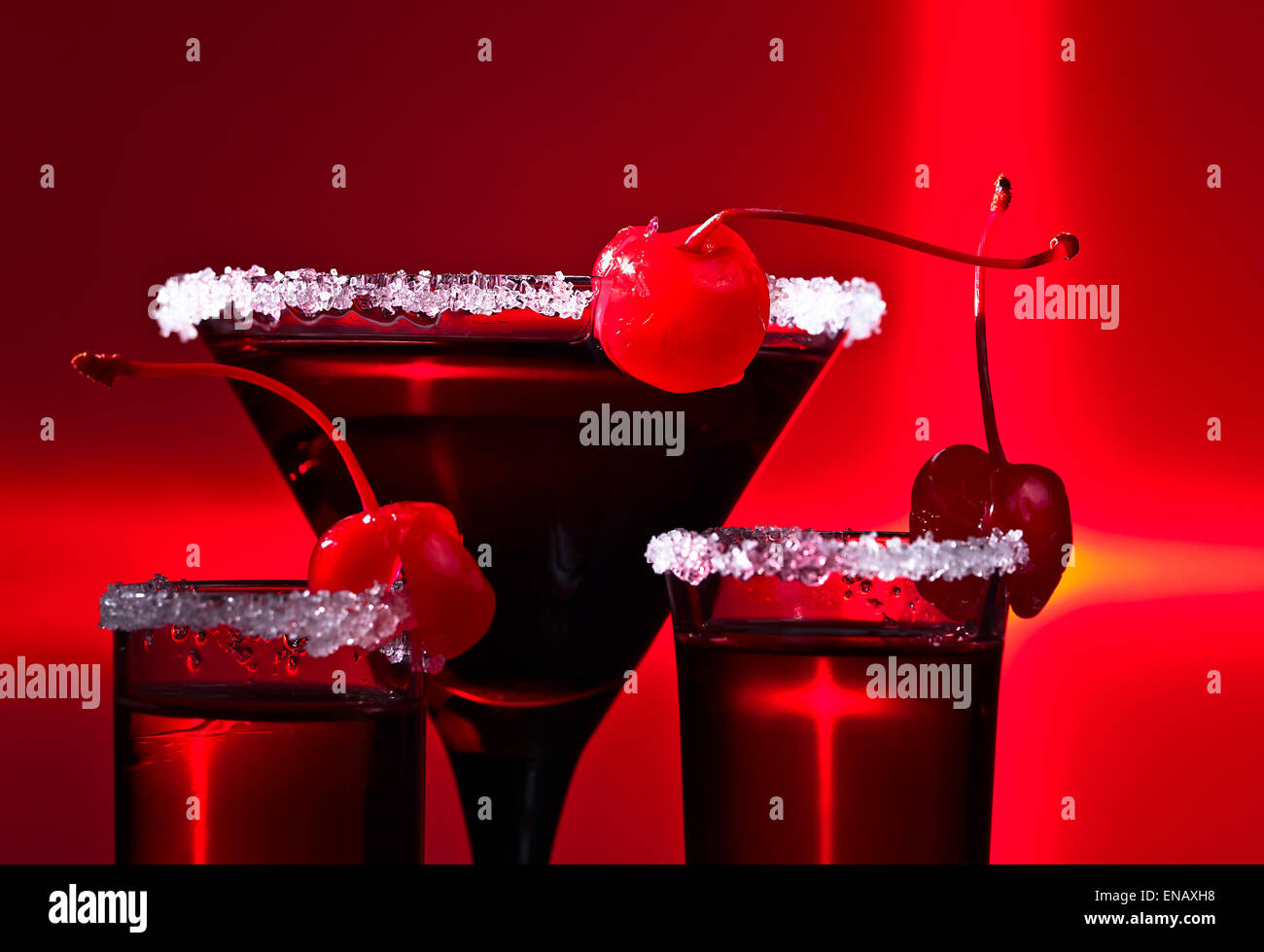 alcoholic drinks with sweet cherry on red background Stock Photo - Alamy