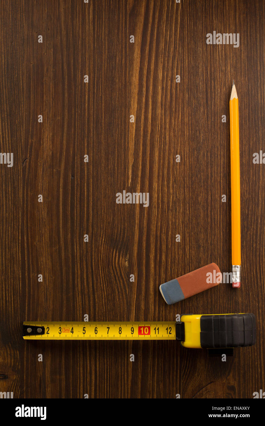 tape measure and pencil on wooden texture Stock Photo - Alamy