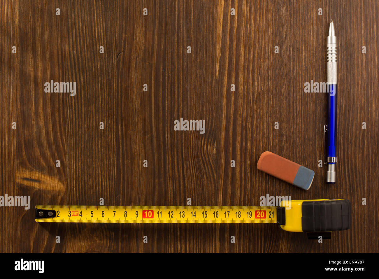 tape measure and pencil on wooden texture Stock Photo - Alamy