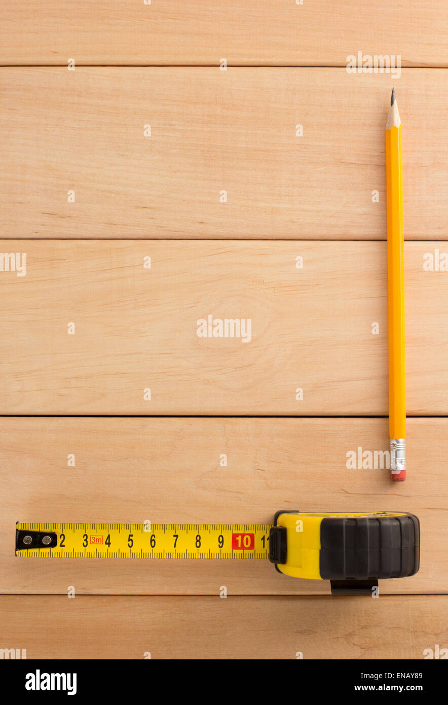 tape measure and pencil on wooden texture Stock Photo - Alamy