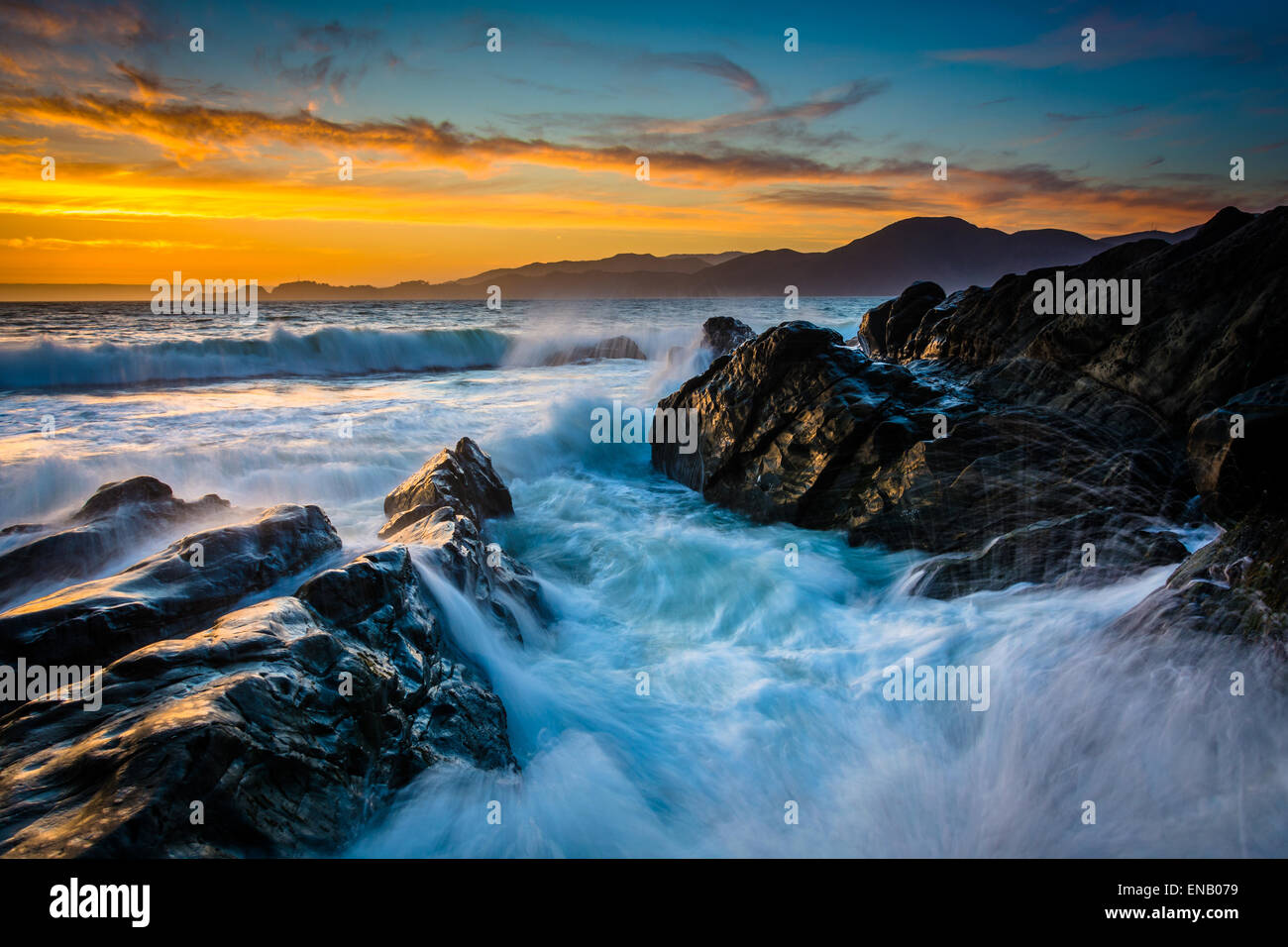 Waves and rocks in the San Francisco Bay at sunset, seen from Baker ...
