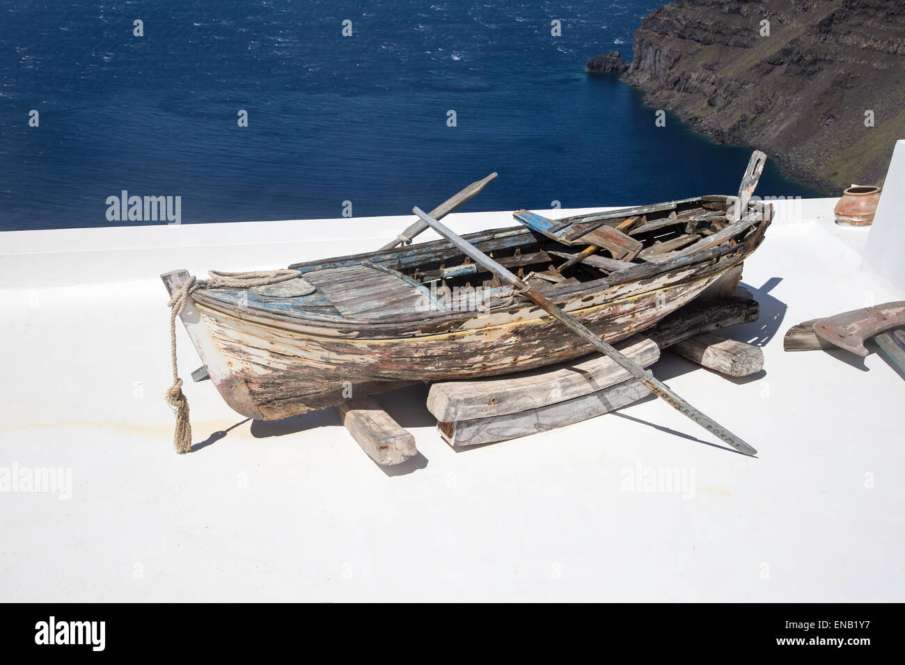 Old wooden rowing boat and oars used for display purposes as an exhibit ...