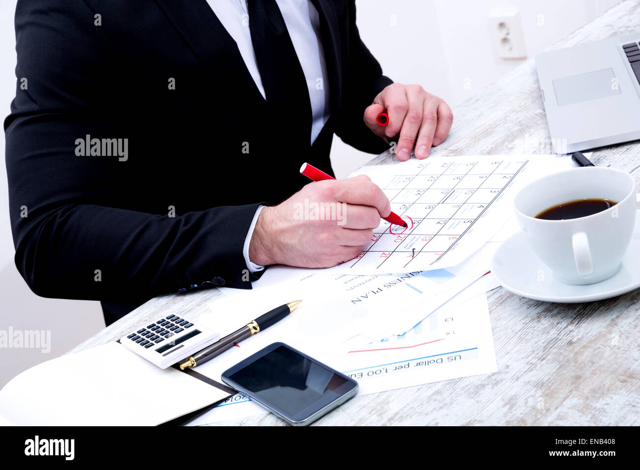 Businessman checking appointments in the calendar at the office Stock ...
