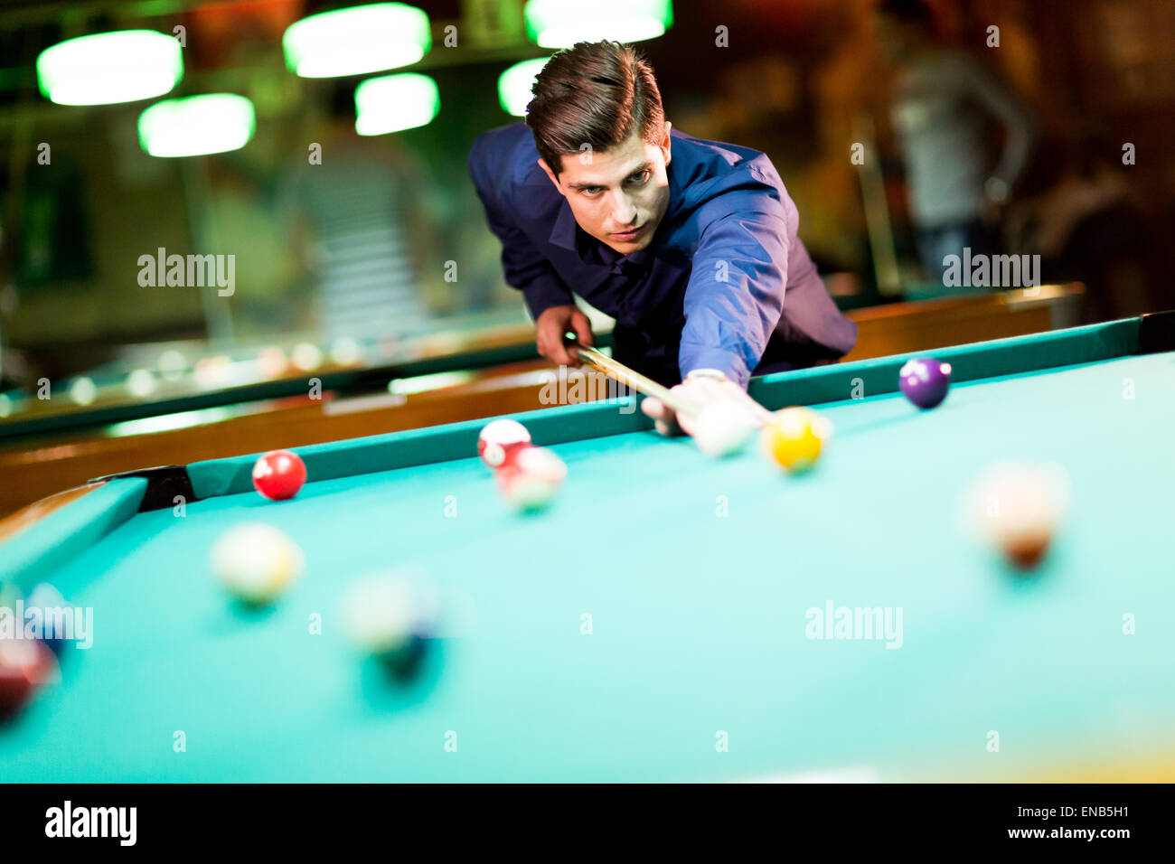 Young man playing pool Stock Photo - Alamy