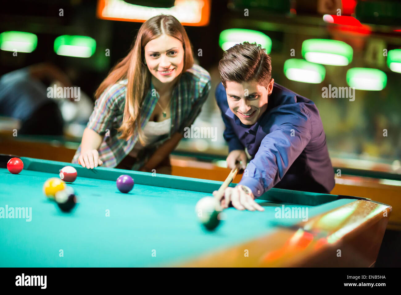 Young couple playing pool Stock Photo - Alamy