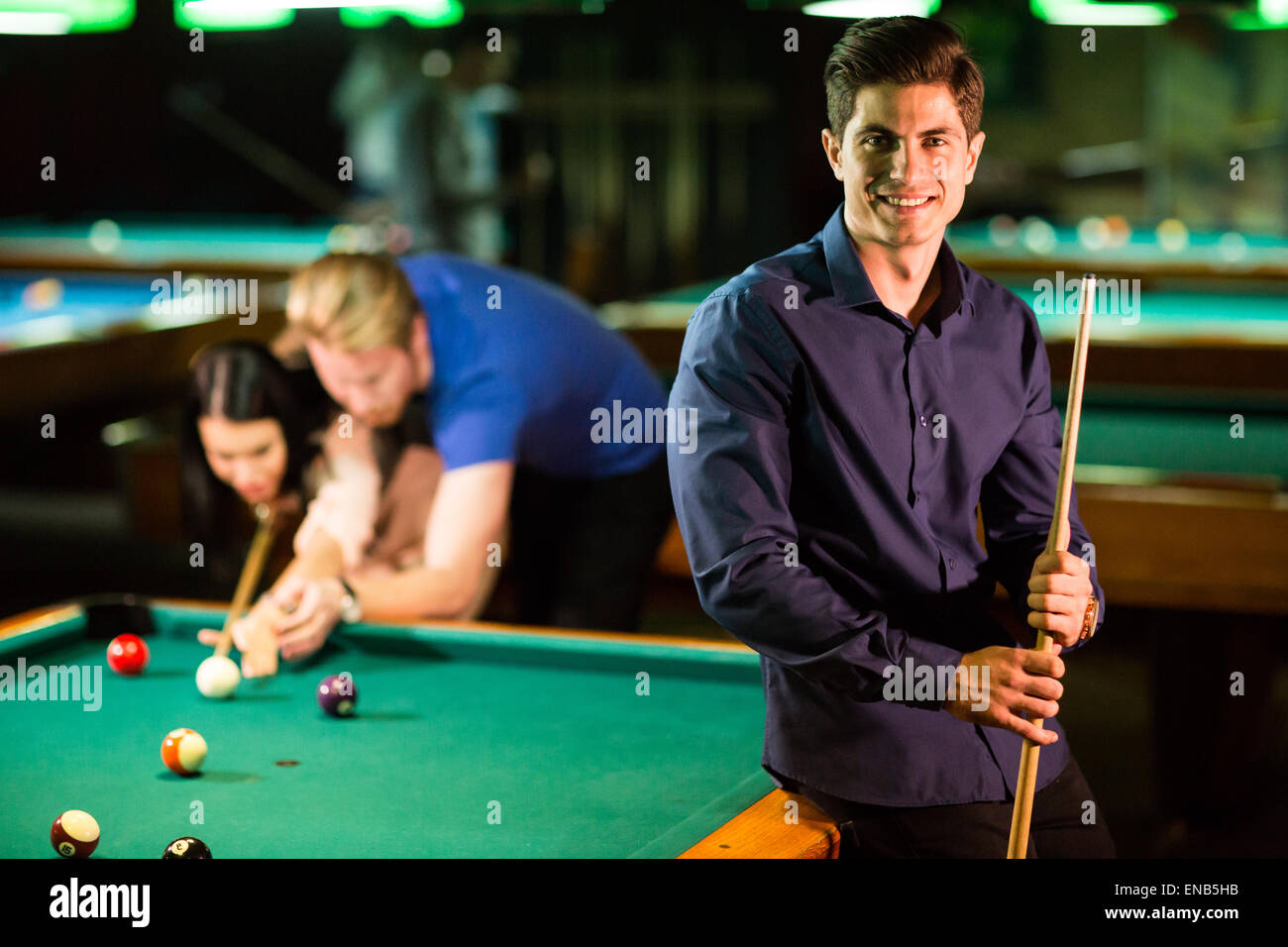 Young people playing pool Stock Photo - Alamy