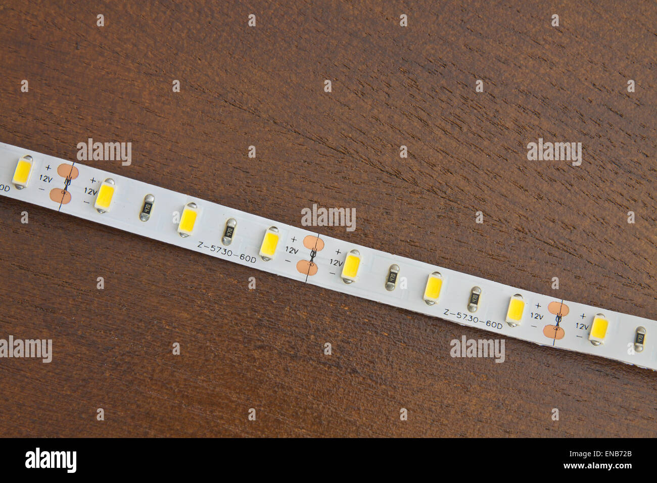 LED strip wound on a roll of brown wooden board Stock Photo - Alamy