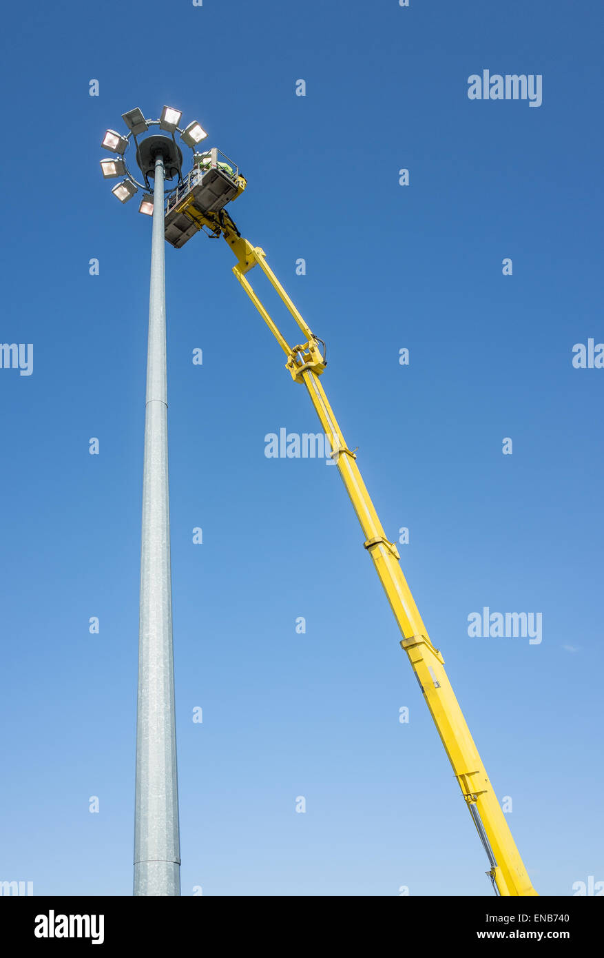 Changing a bulb on a tall lamp post Stock Photo - Alamy