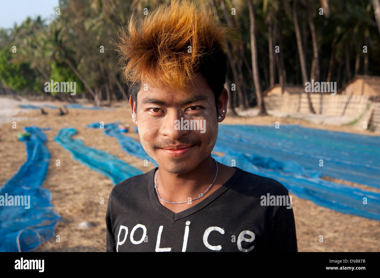 Portrait of a young Burmese fisherman with funky dyed hair on Ngapali ...