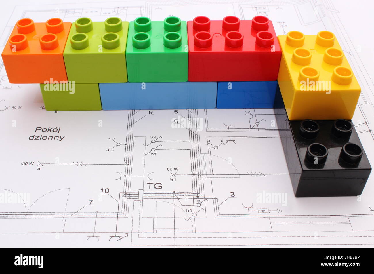 Wall of colorful building blocks lying on construction drawing of house ...