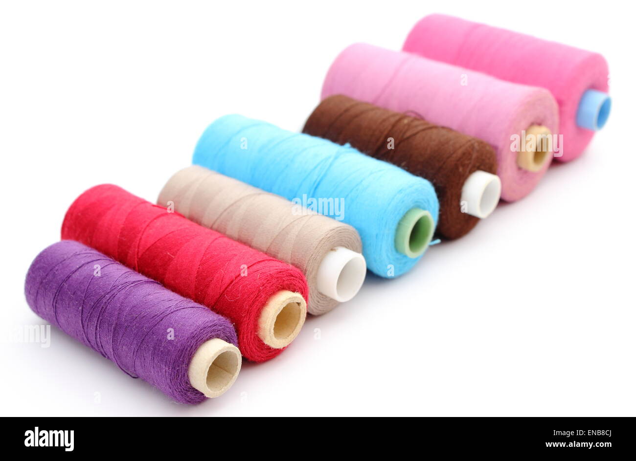 Colorful spools of thread isolated on white background Stock Photo - Alamy