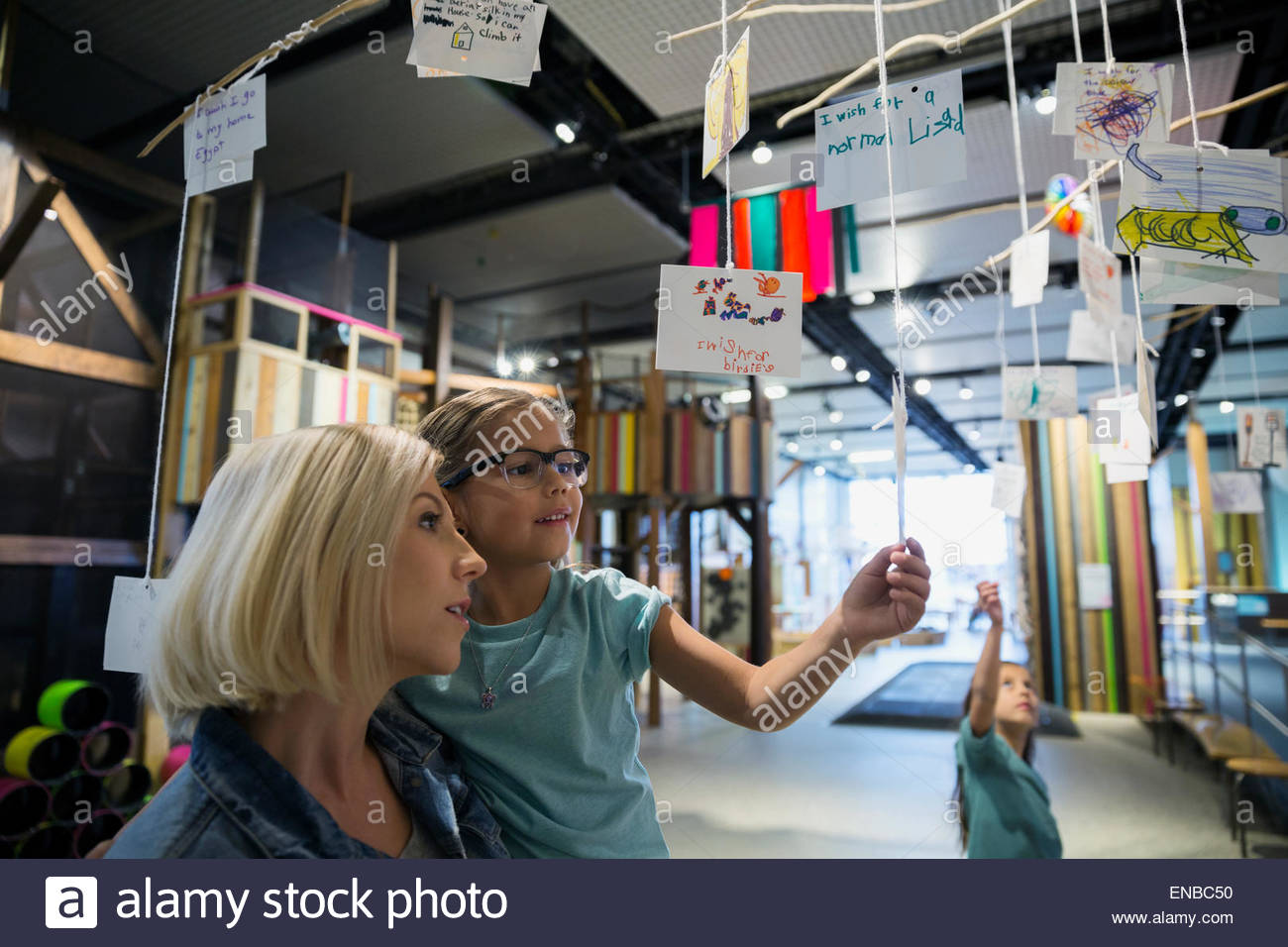 Mother and daughter viewing hanging mobile science center Stock Photo ...