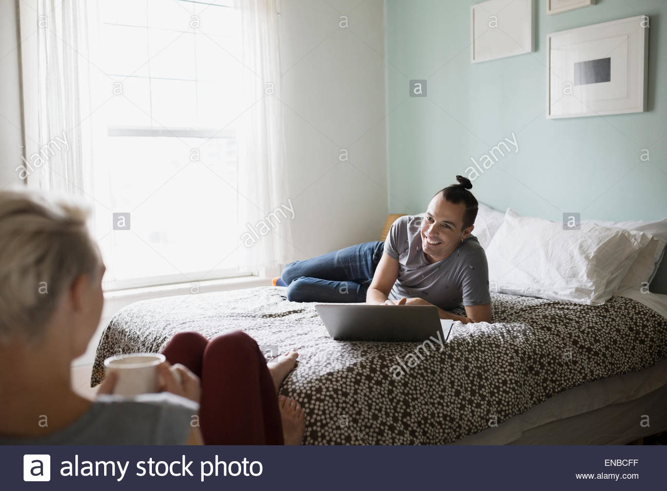 Women watching laptop in bed hi-res stock photography and images - Alamy