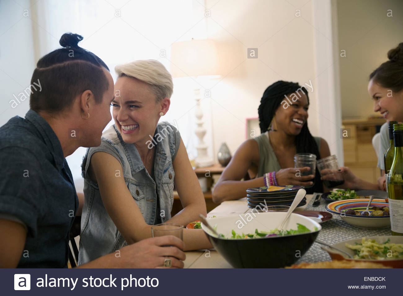 Couple laughing and talking at dinner party Stock Photo - Alamy