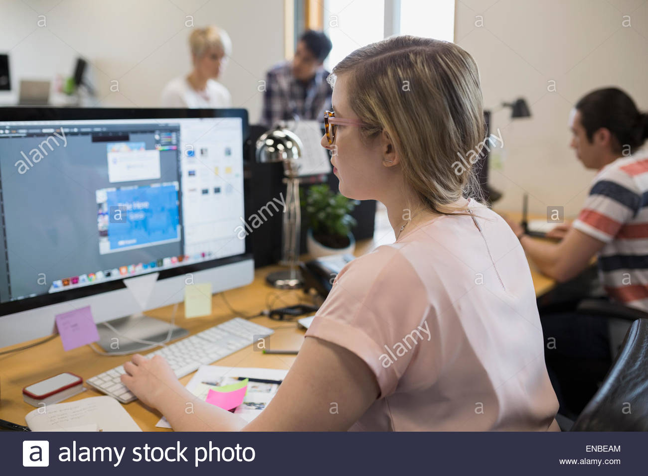 Graphic designer working at computer in office Stock Photo - Alamy