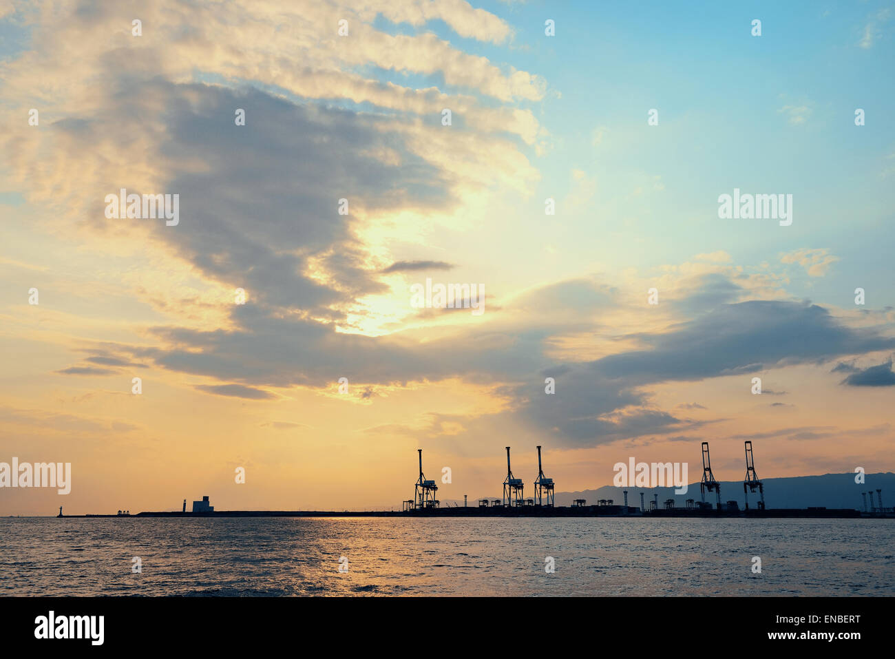 Osaka seaport with crane silhouette at sunset. Japan Stock Photo - Alamy