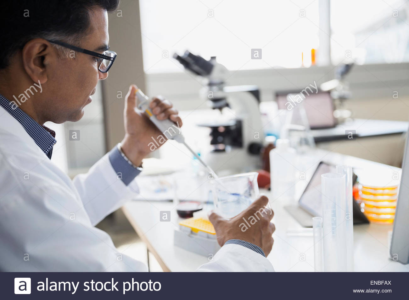 Scientist holding pipette hi-res stock photography and images - Alamy