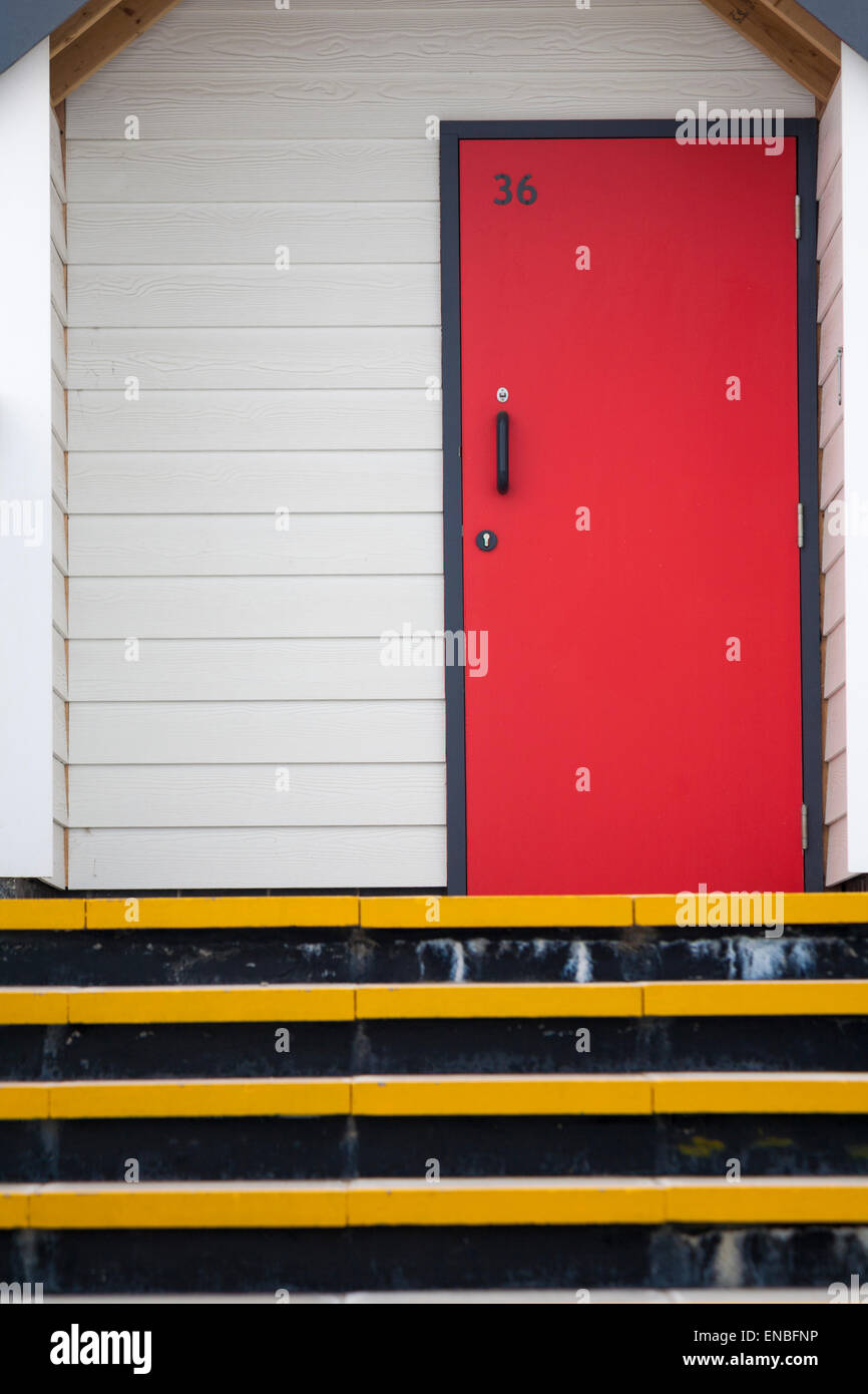 New colourful number 36 red beach hut with yellow steps leading up ...