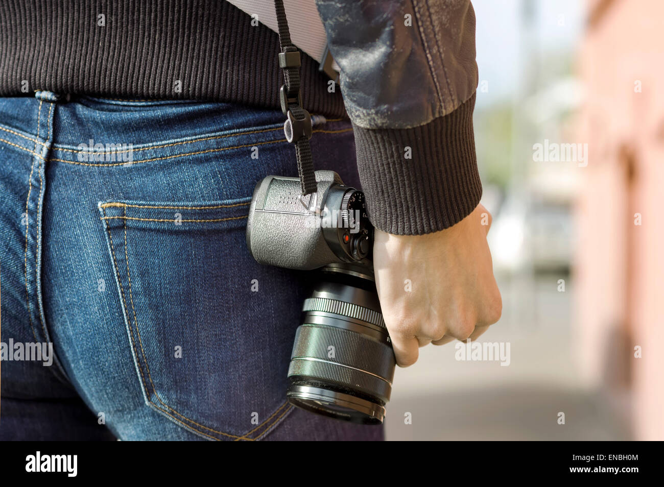 Female photographer, walking down the street and carrying her photo ...