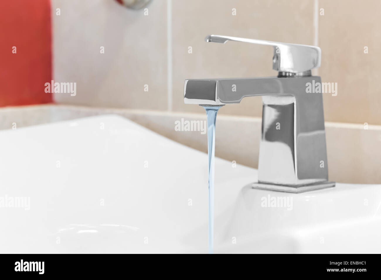 Faucet in bathroom, water is running Stock Photo - Alamy