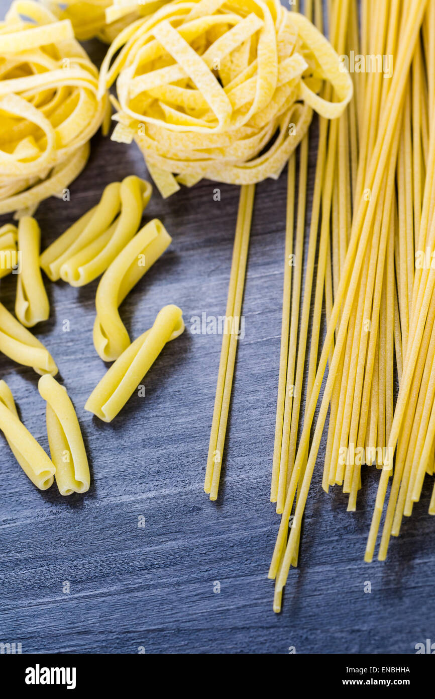 Variety of organic dry pasta on wood board Stock Photo - Alamy