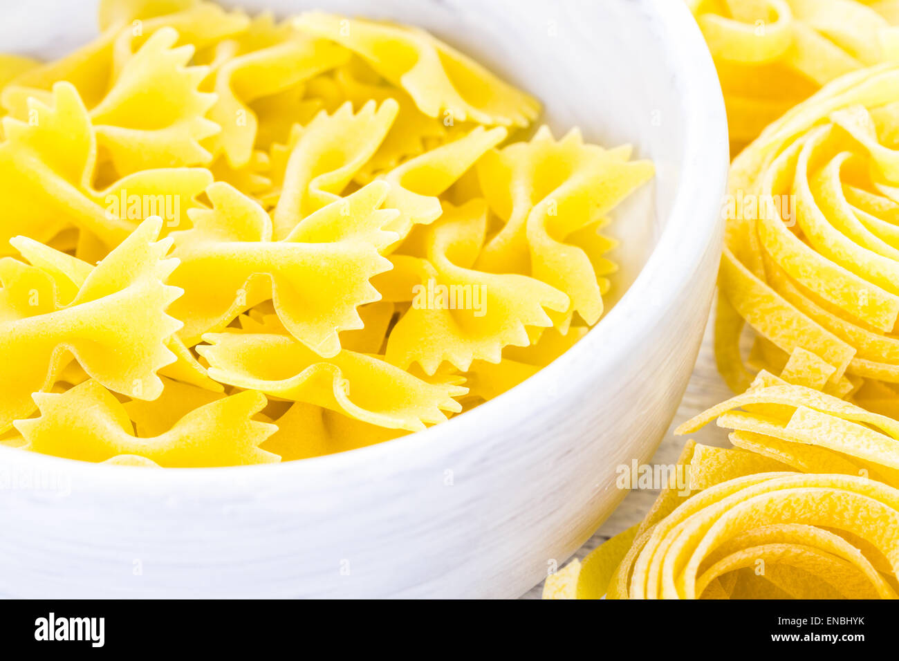 Variety of yellow dry pasta in small round bowls Stock Photo - Alamy