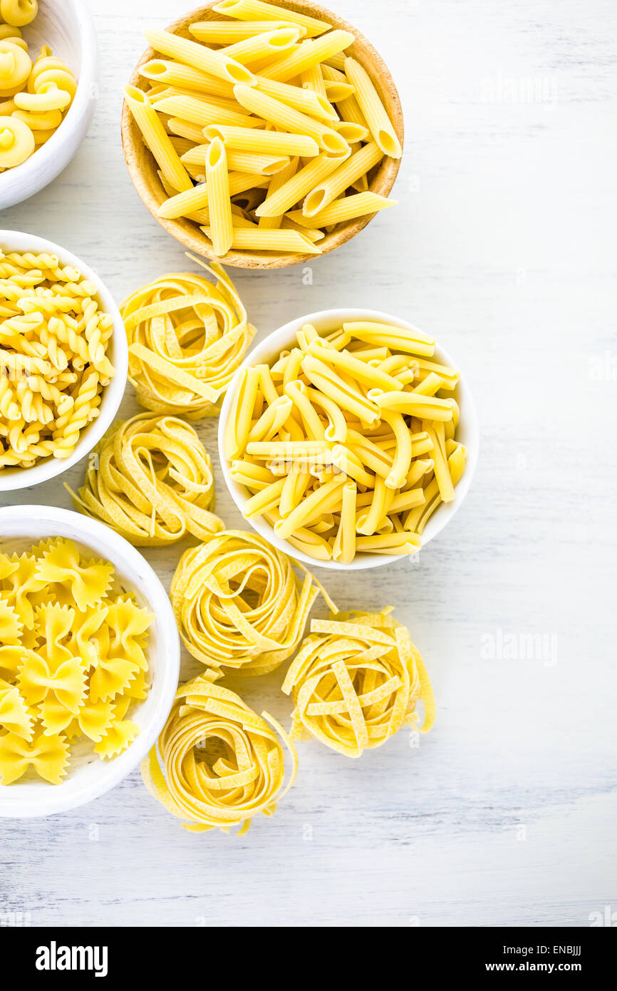 Variety of yellow dry pasta in small round bowls Stock Photo - Alamy