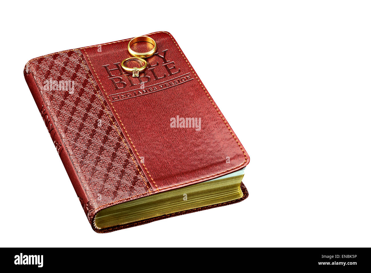 Closed studio prop Bible cover with gold and diamond Wedding Rings ...