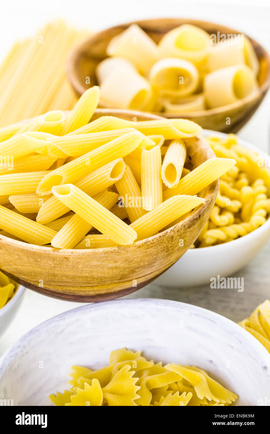 Variety of yellow dry pasta in small round bowls Stock Photo - Alamy
