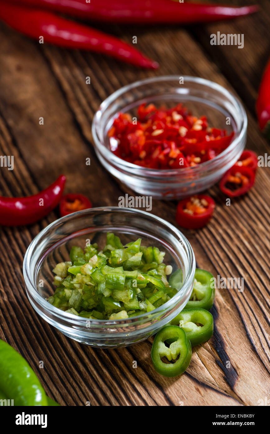 Mixed cutted Chilis (red and green) on vintage wooden background Stock ...