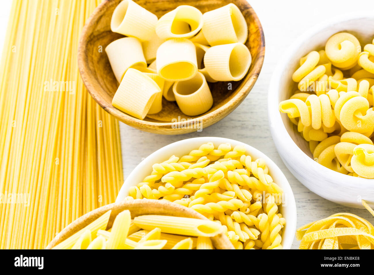 Variety of yellow dry pasta in small round bowls Stock Photo - Alamy