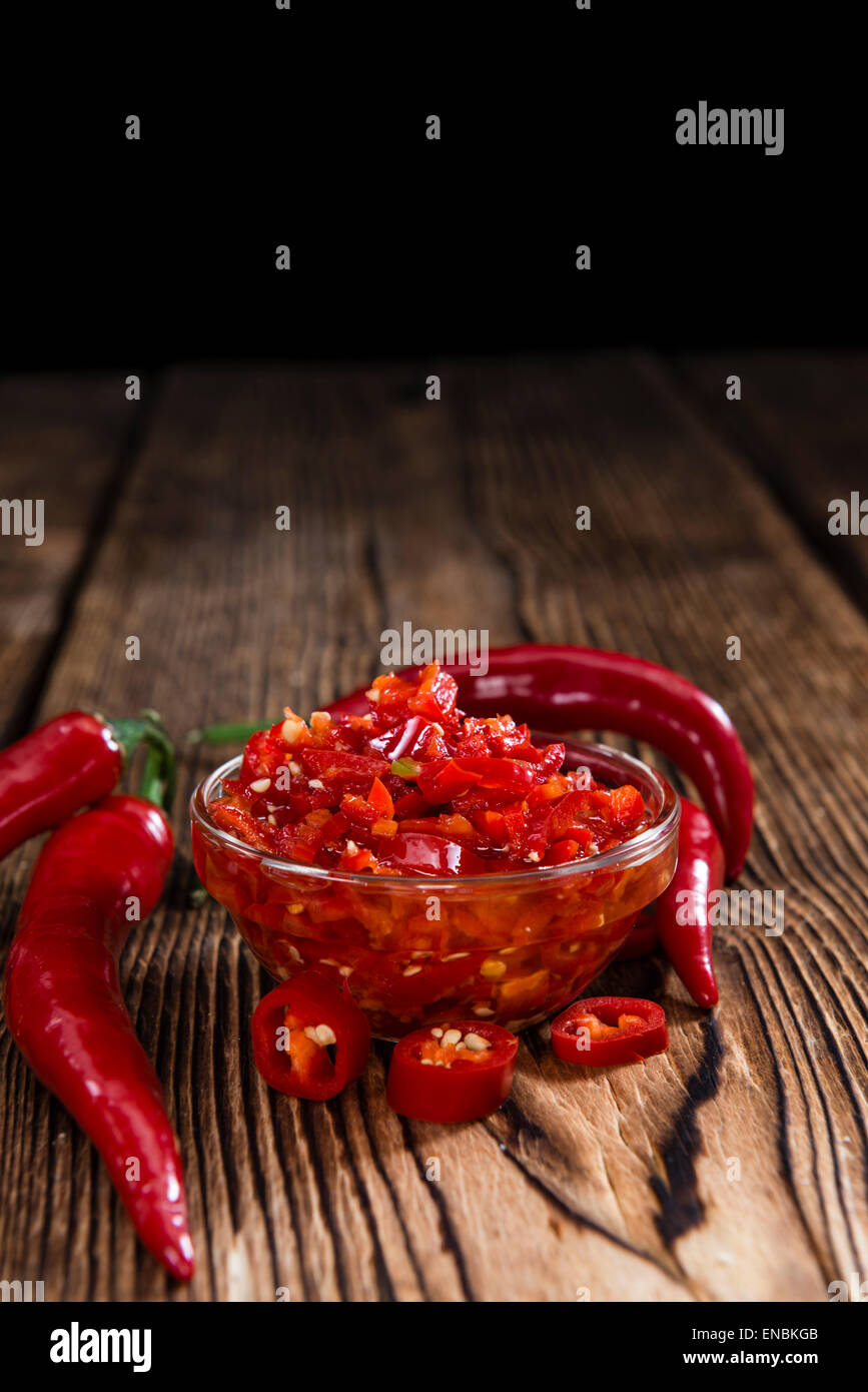 Small bowl with preserved red Chilis (on wooden background Stock Photo ...