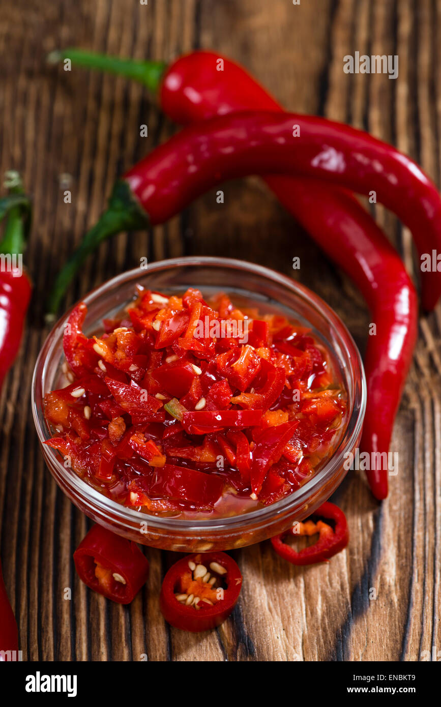 Small bowl with preserved red Chilis (on wooden background Stock Photo ...