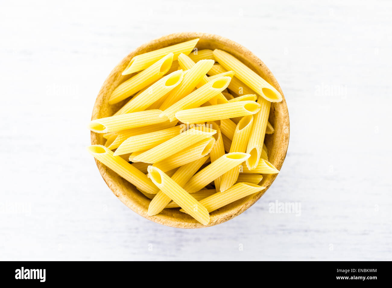 Organic dry pasta in small round bowl Stock Photo - Alamy