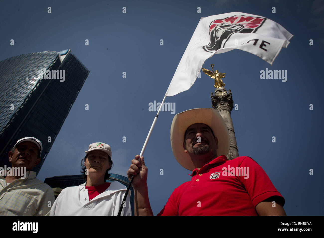 Mexico City. 1st May, 2015. A resident holds a flag during a march in ...