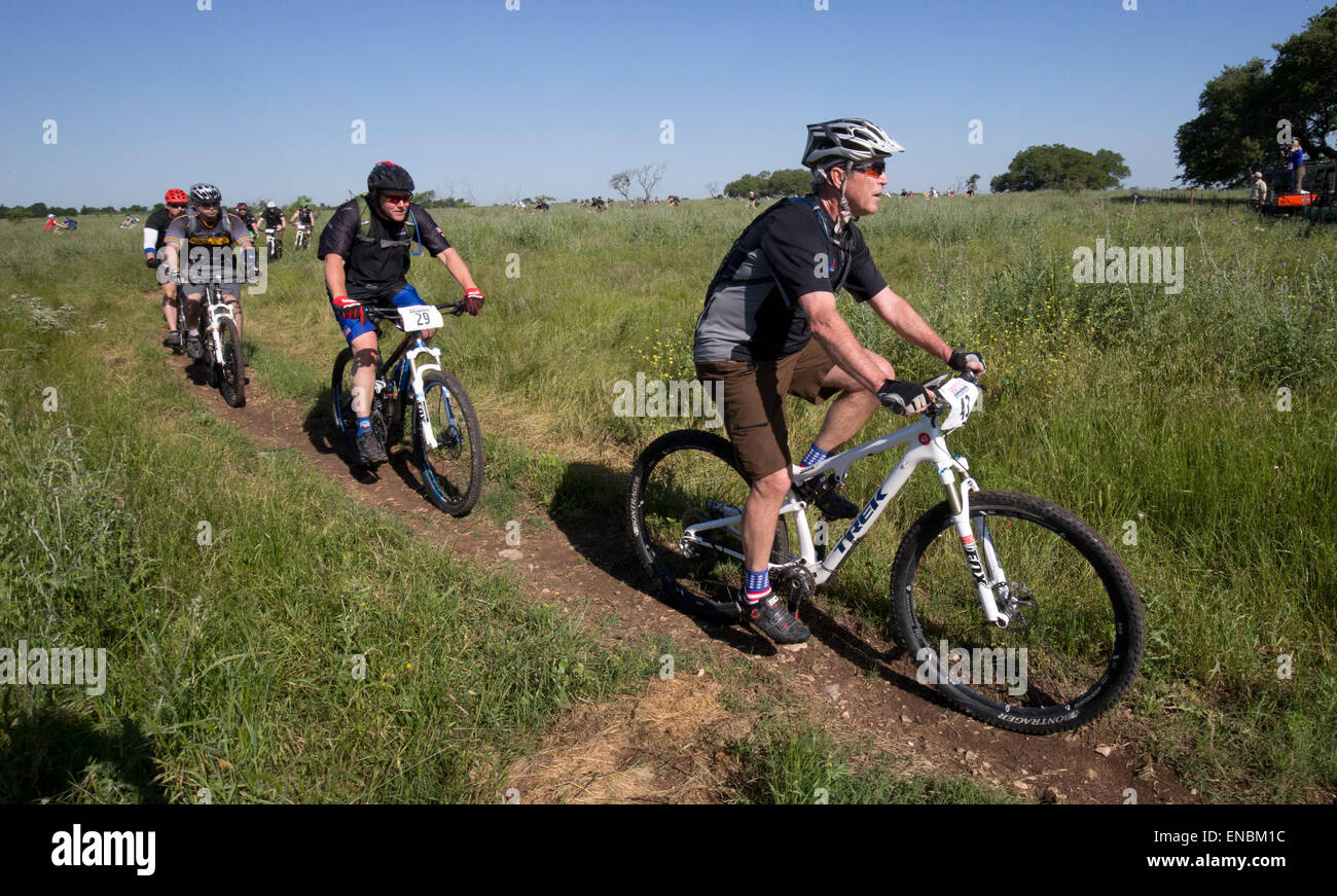 Former U.S. President George W. Bush, r, rides during the Bush ...