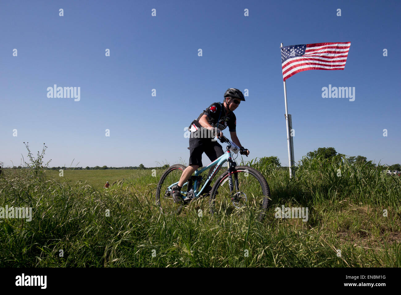 A mountain biker passes U.S. flag at former Pres. George W. Bush's Bush ...