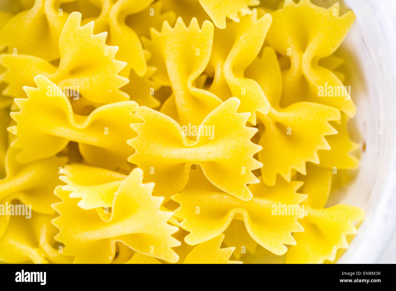 Organic dry pasta in small round bowl Stock Photo - Alamy