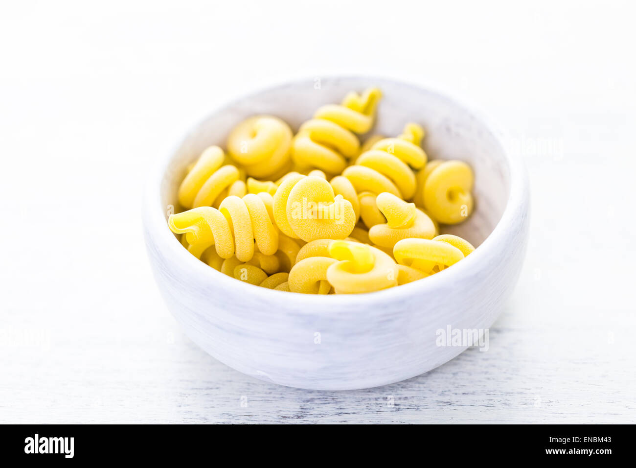 Organic dry pasta in small round bowl Stock Photo - Alamy