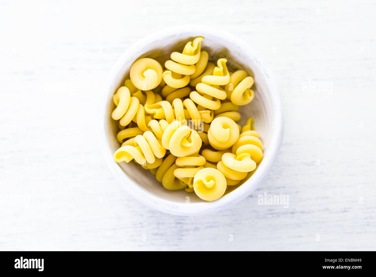 Organic dry pasta in small round bowl Stock Photo - Alamy