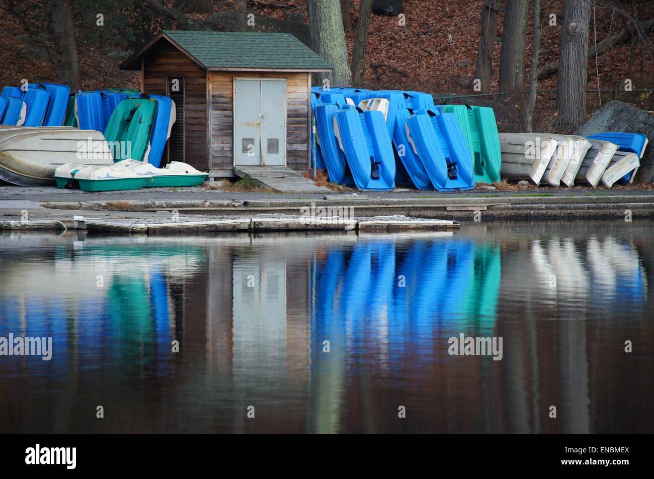Blue and green boats reflecting in the water Stock Photo - Alamy