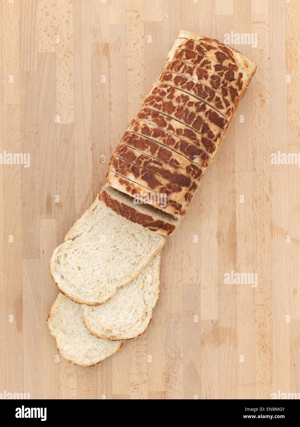 A loaf of bread on a wooden bench top Stock Photo - Alamy
