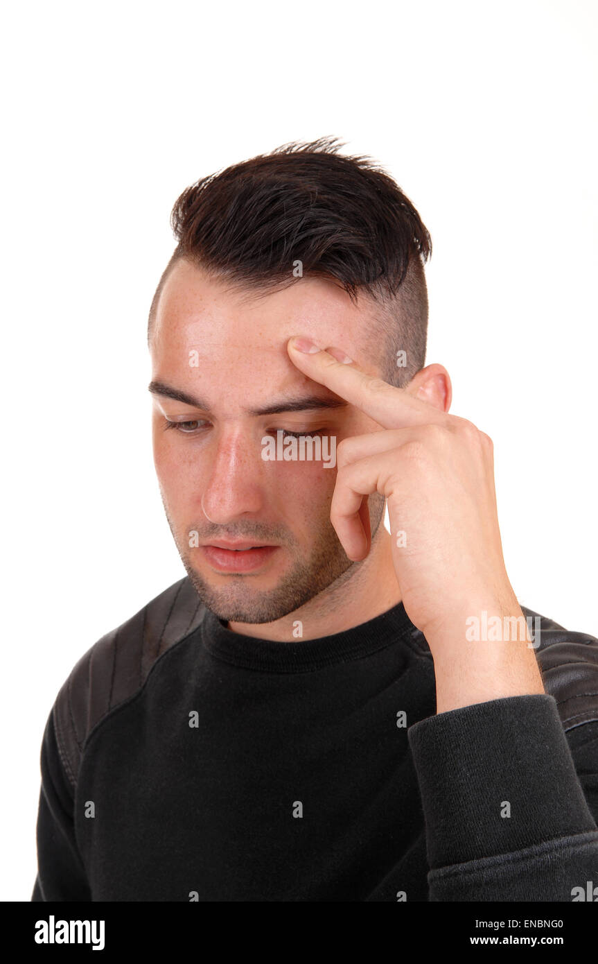 A young handsome man with his finger on his forehead and hard thinking ...