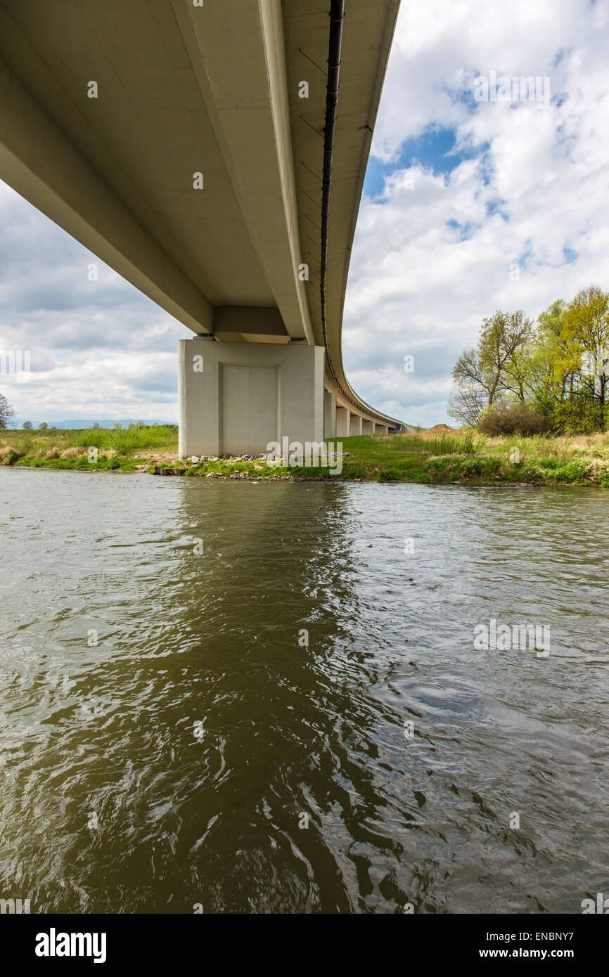 Modern long bridge over the small river Stock Photo - Alamy