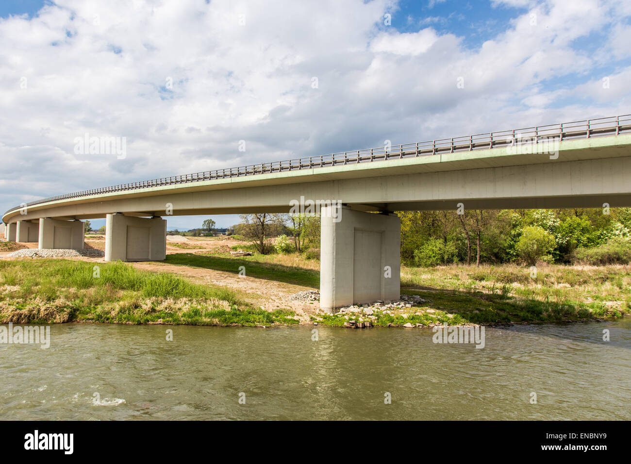 Modern long bridge over the small river Stock Photo - Alamy