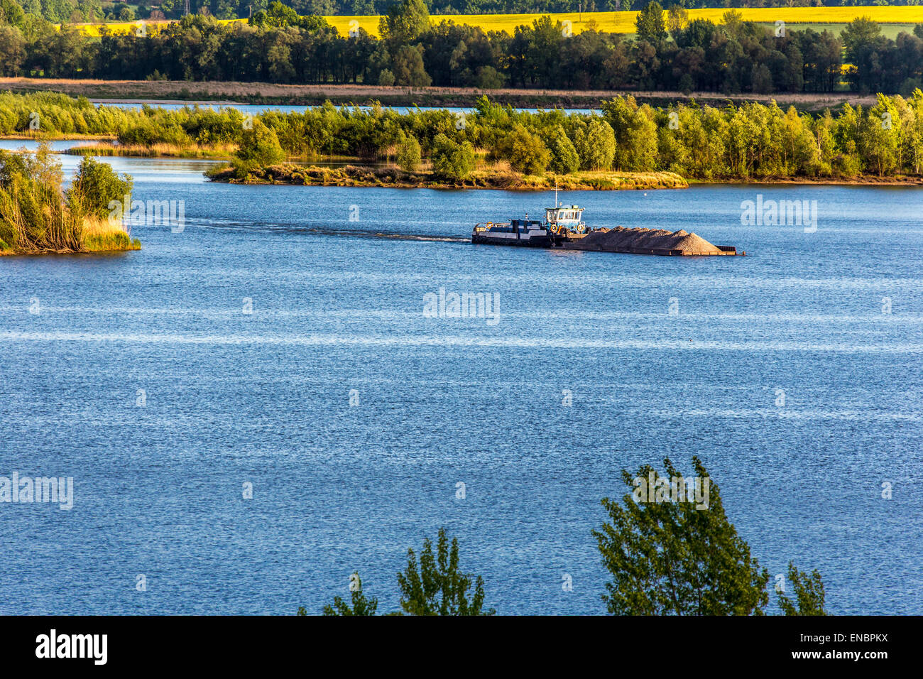The barge with the sand on the lake Stock Photo - Alamy