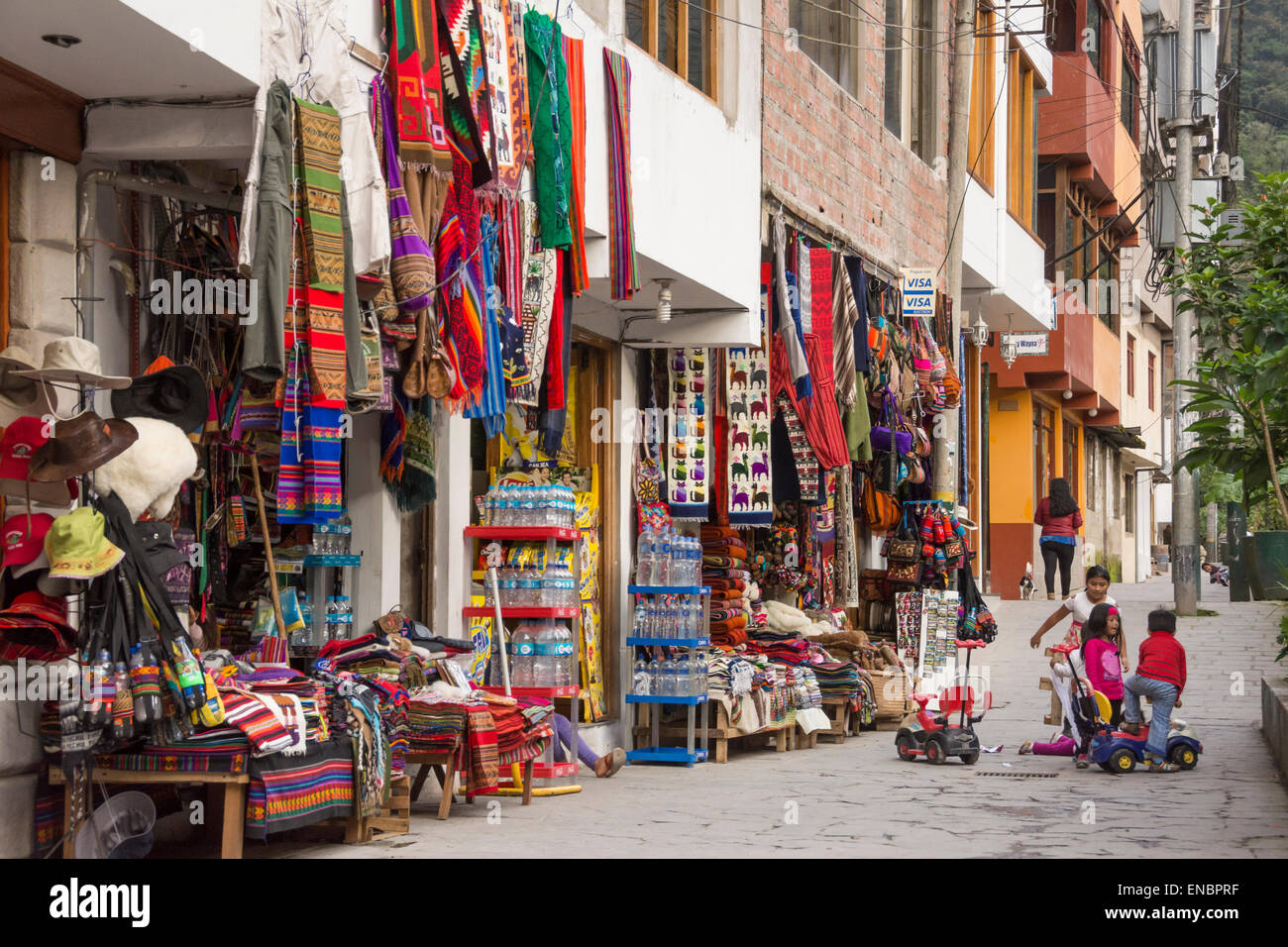 Souvenir shops and kids playing on walkway in Machu Picchu Pueblo, Peru ...